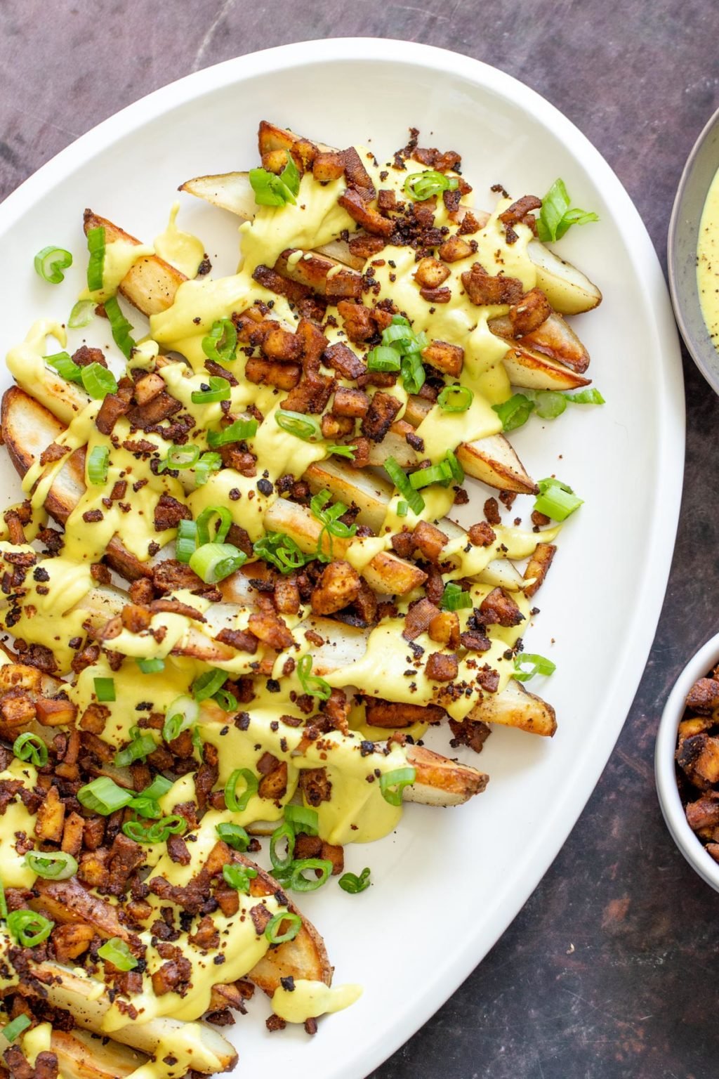 Loaded Vegan Baked Potato Wedges with Cheese Sauce & Vegan Bacon